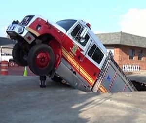 Video: Ky. fire truck falls through collapsed parking lot