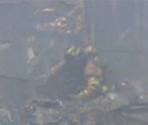 Video: Firefighter falls through roof, escapes injury